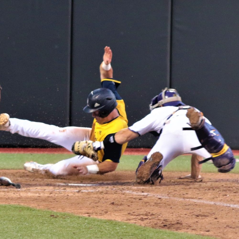060119-08__ecu-quinnipiac_Pirate catcher Jake Washer applies the tag at ...